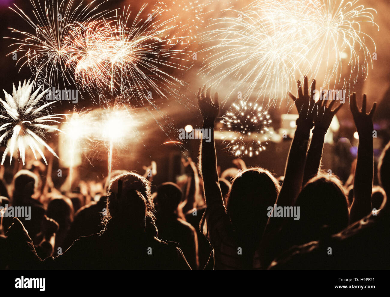 New Year concept - cheering crowd and fireworks Stock Photo - Alamy