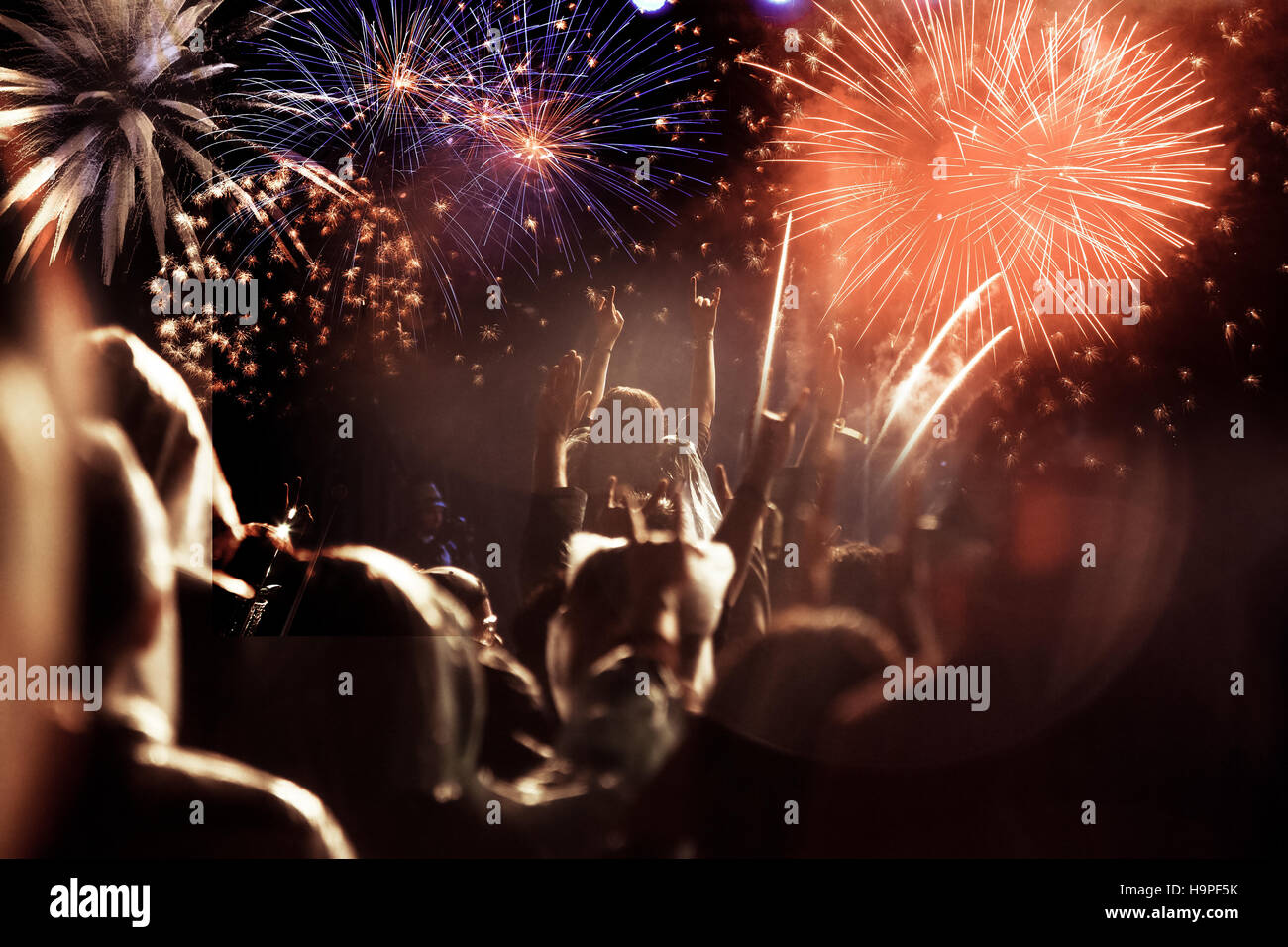 New Year concept - cheering crowd and fireworks Stock Photo - Alamy