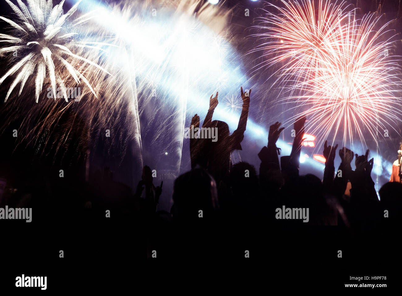 New Year concept - cheering crowd and fireworks Stock Photo - Alamy