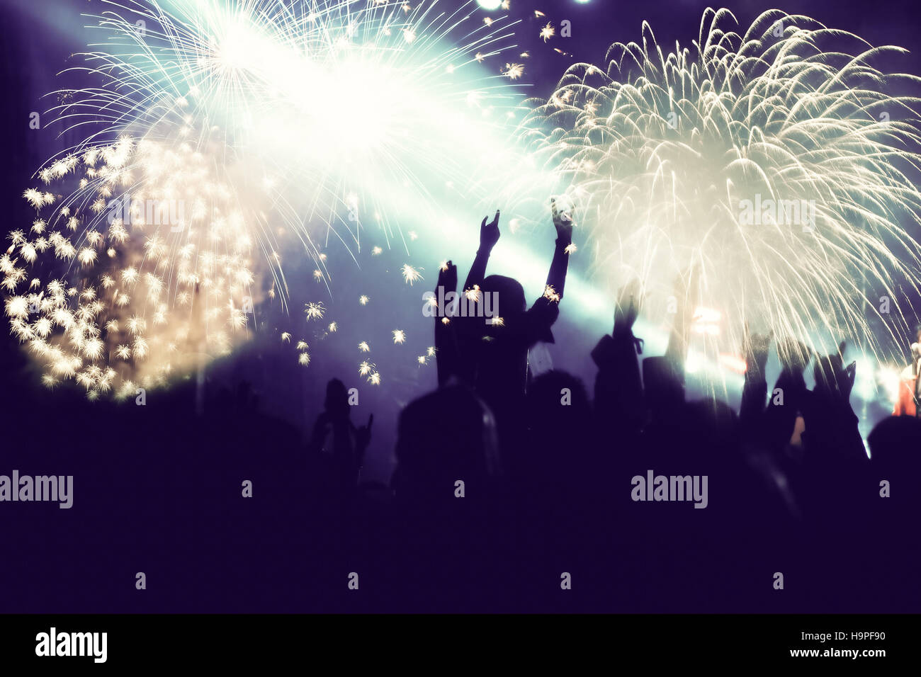 New Year concept - cheering crowd and fireworks Stock Photo - Alamy