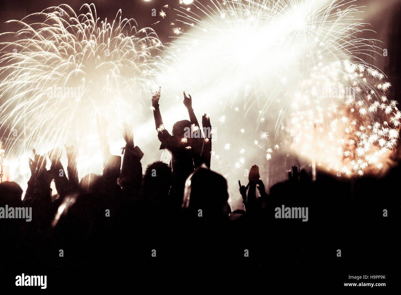 New Year concept - cheering crowd and fireworks Stock Photo - Alamy