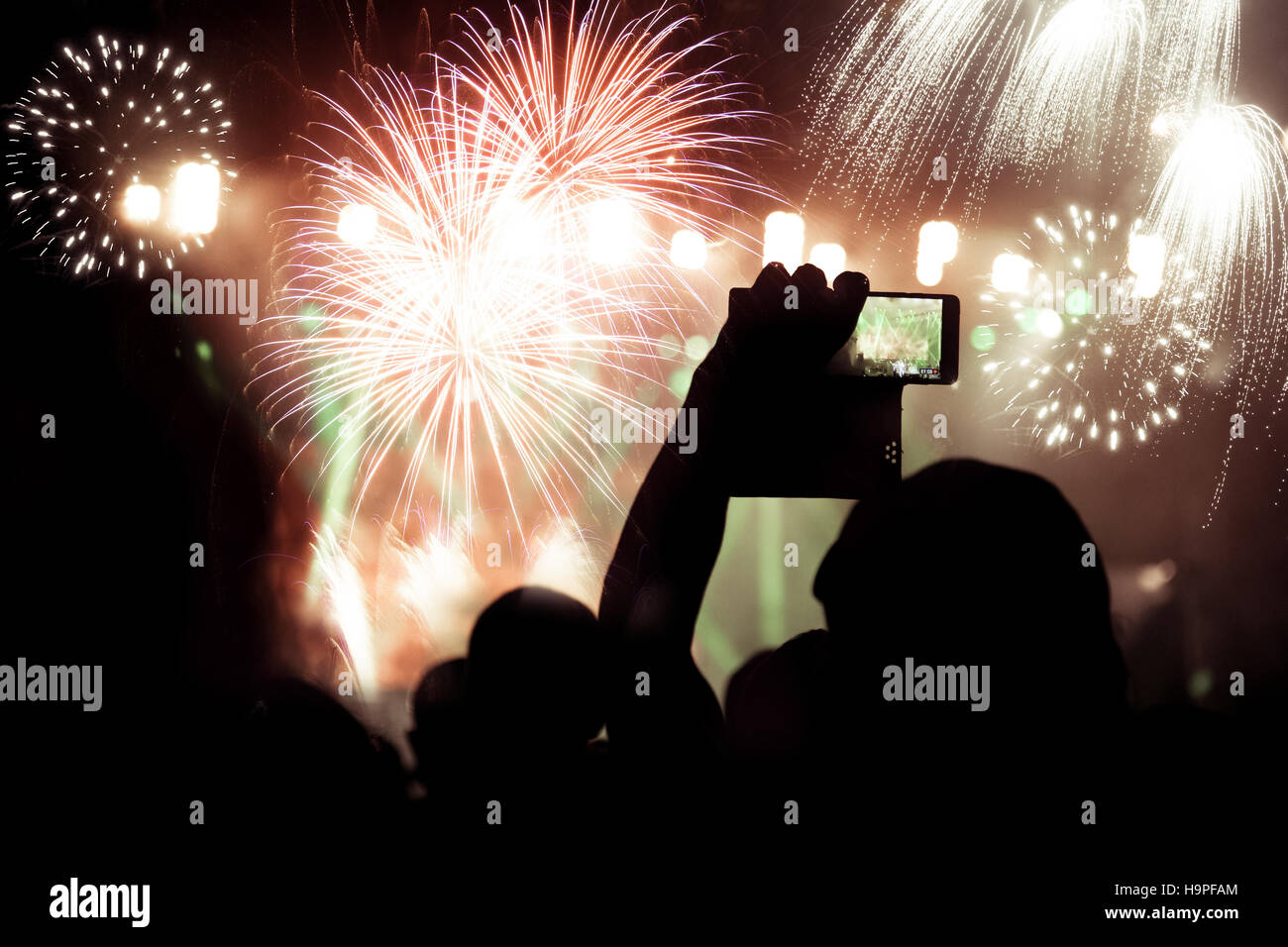 New Year concept - cheering crowd and fireworks Stock Photo - Alamy