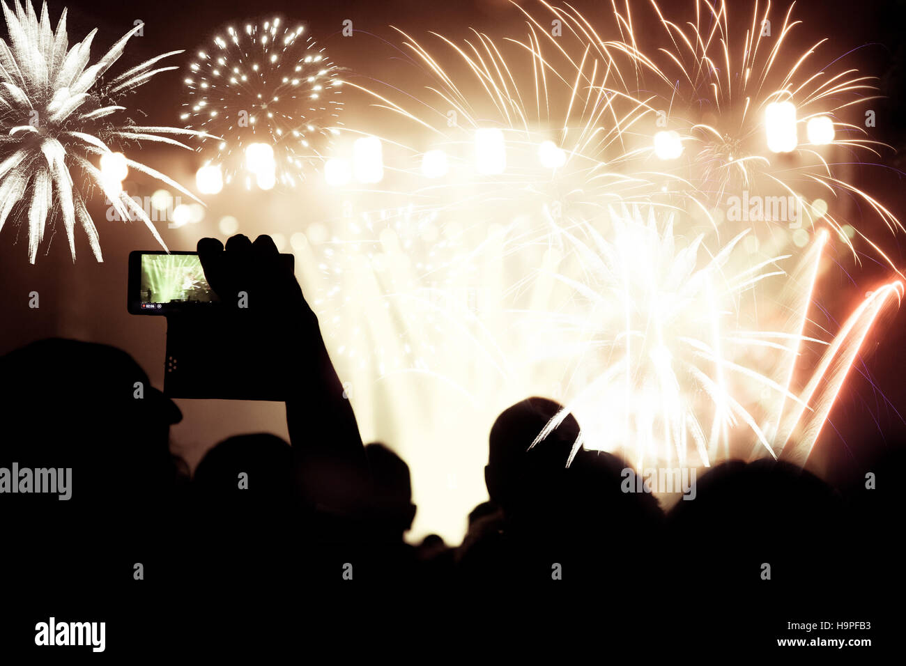 New Year concept - cheering crowd and fireworks Stock Photo - Alamy
