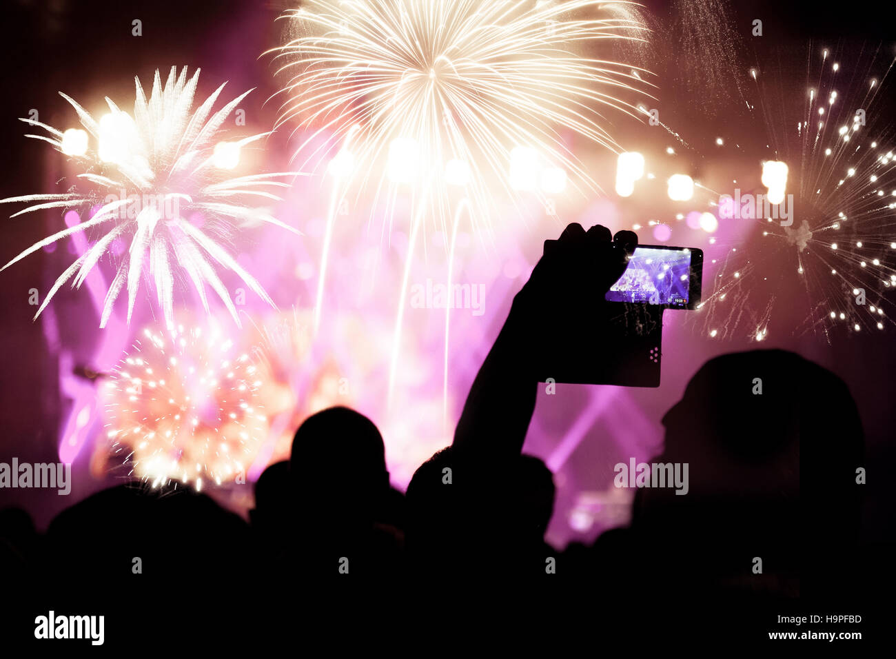 New Year concept - cheering crowd and fireworks Stock Photo - Alamy