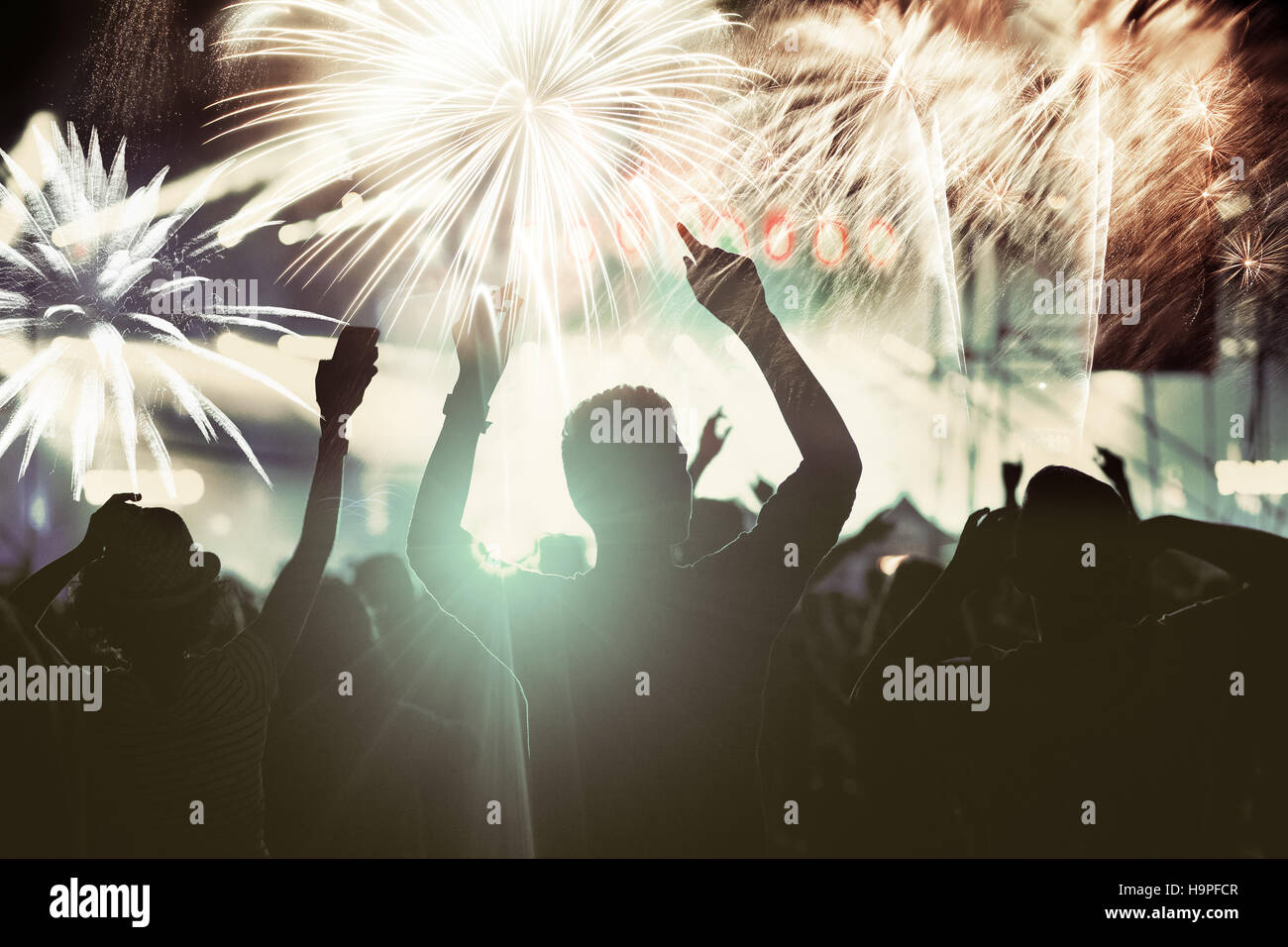 New Year concept - cheering crowd and fireworks Stock Photo - Alamy