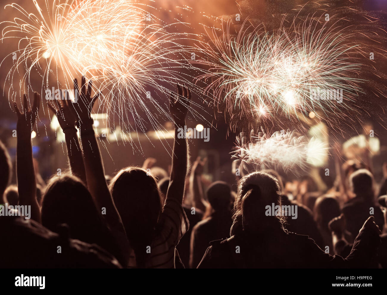 New Year concept - cheering crowd and fireworks Stock Photo - Alamy