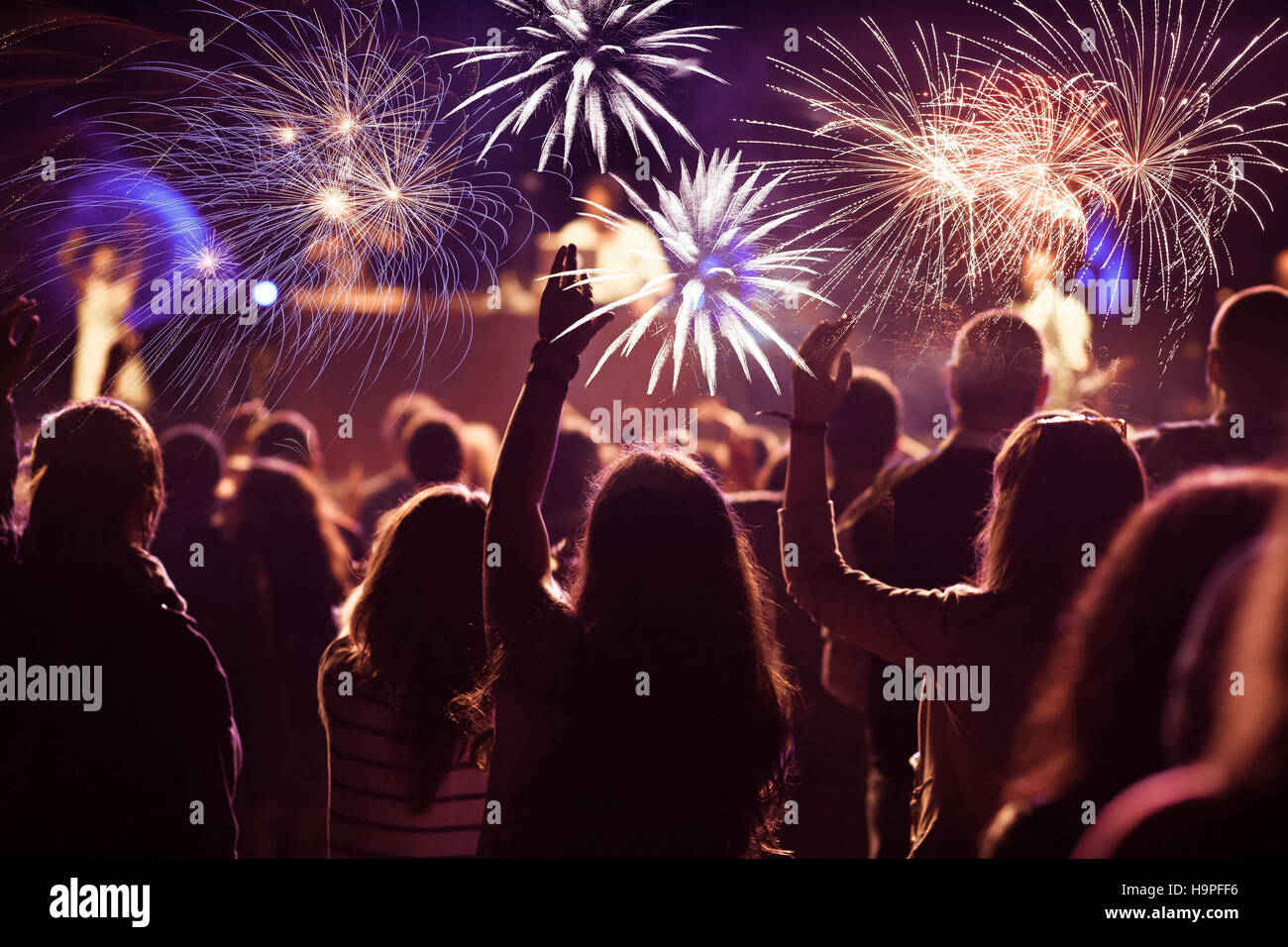 New Year concept - cheering crowd and fireworks Stock Photo - Alamy
