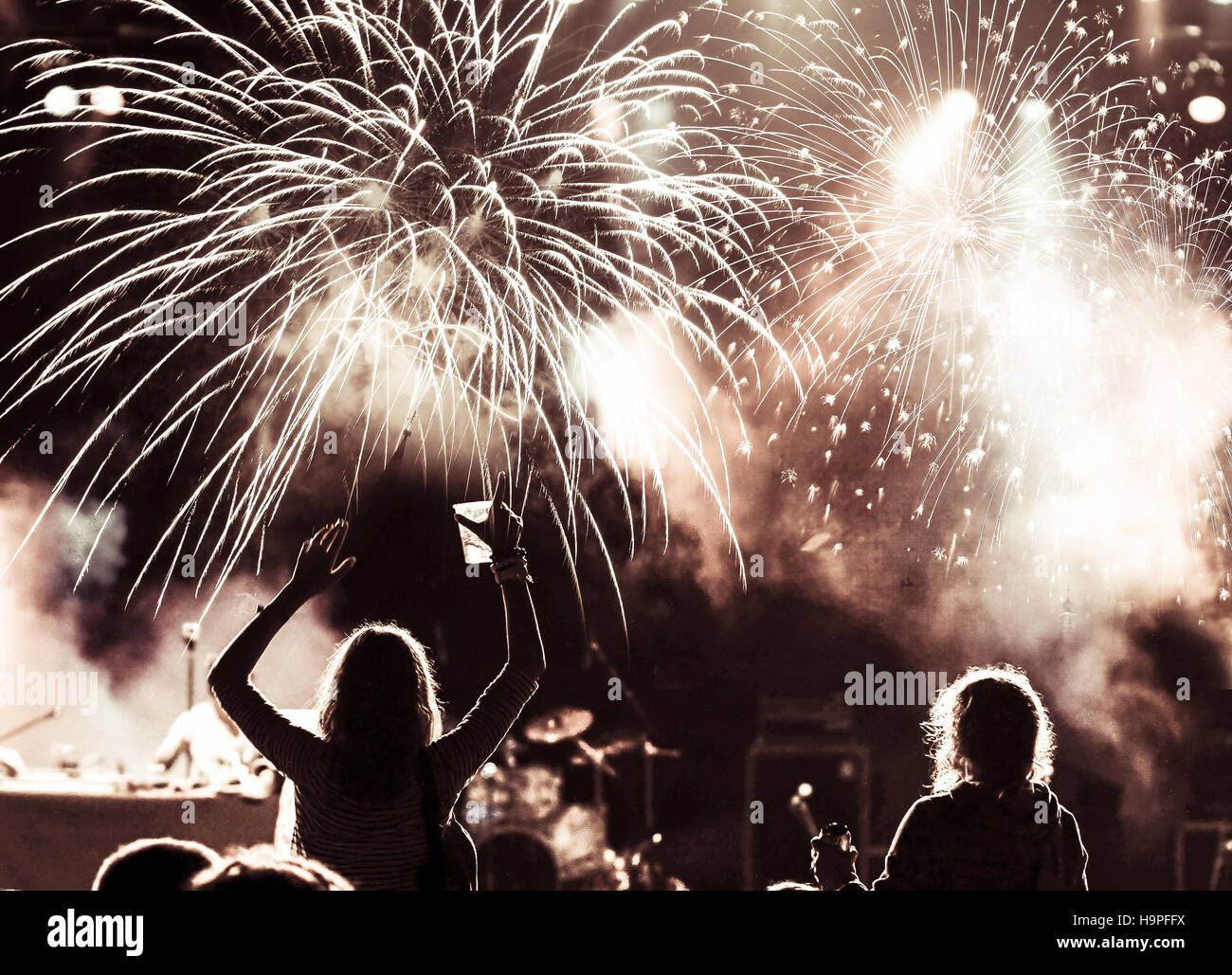New Year concept - cheering crowd and fireworks Stock Photo - Alamy
