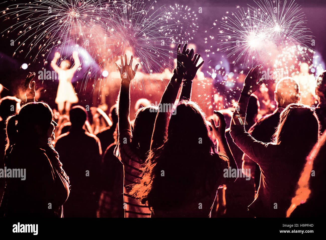 New Year concept - cheering crowd and fireworks Stock Photo - Alamy