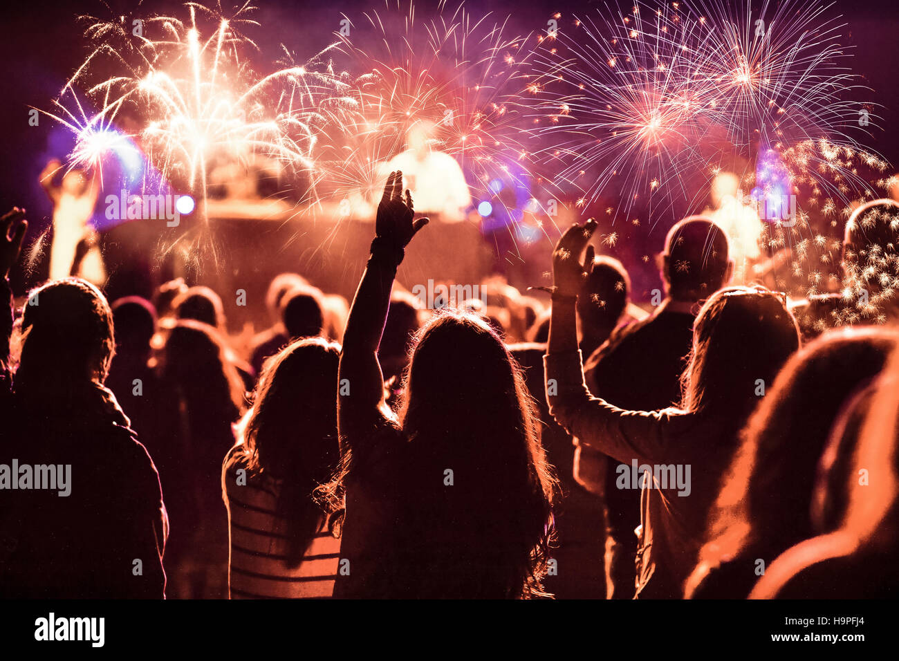 New Year concept - cheering crowd and fireworks Stock Photo - Alamy