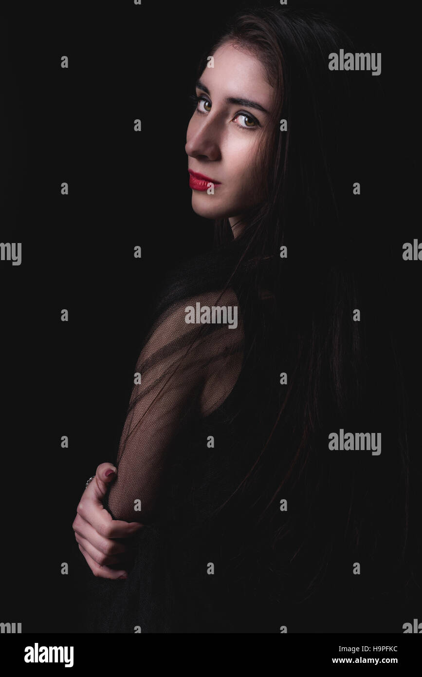 Female on the dark background in low key Stock Photo - Alamy
