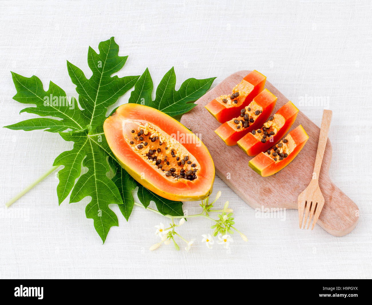 Fresh papaya and papaya slice with papaya leaf on cutting board Stock ...