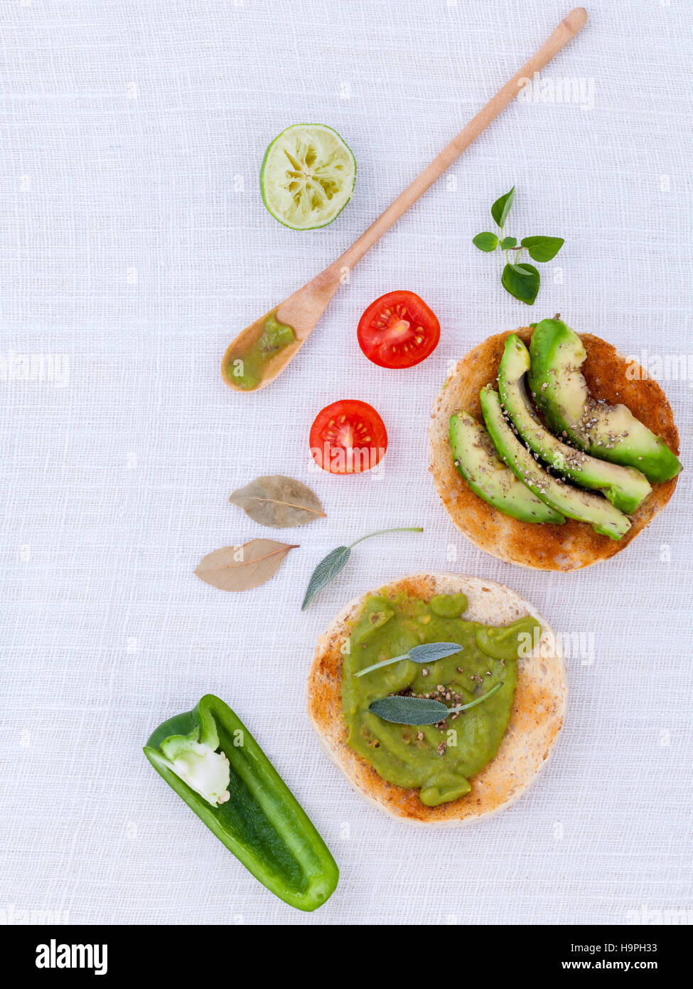Toast with avocado creamy salad and herbs on white table Stock Photo ...
