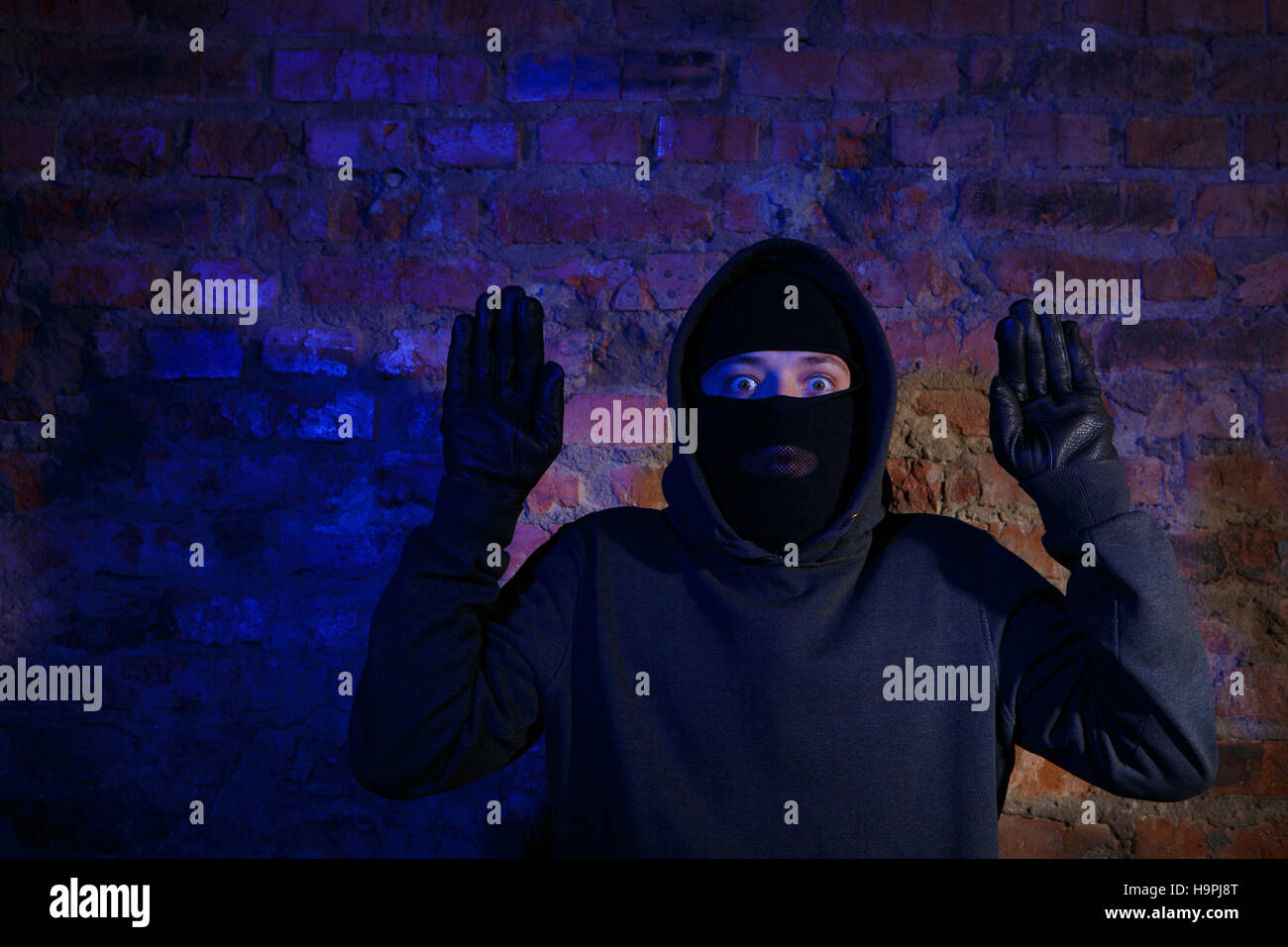 Astonished thief with hands up Stock Photo - Alamy