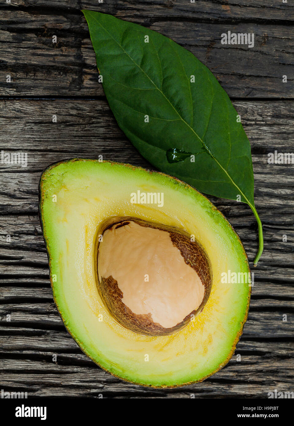 Halved avocado with core in macro shot Stock Photo - Alamy