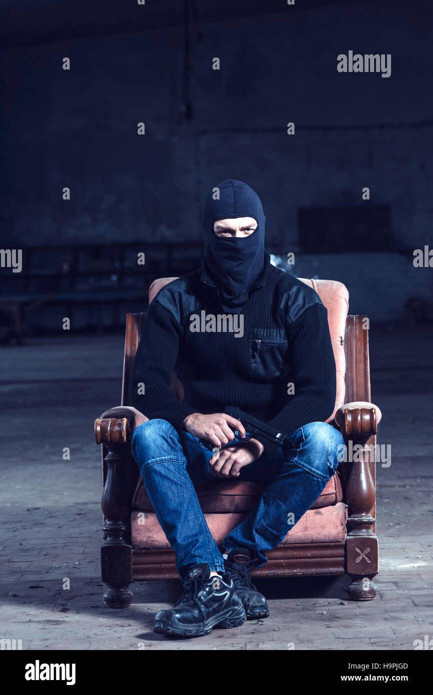 Masked man holding the gun,selctive focus Stock Photo - Alamy