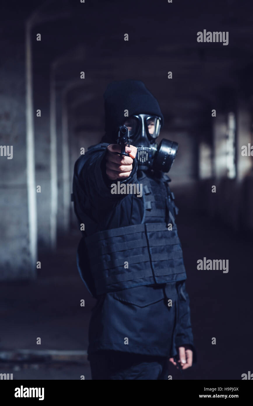 The terrorist with gas mask pointing gun,selective focus Stock Photo ...