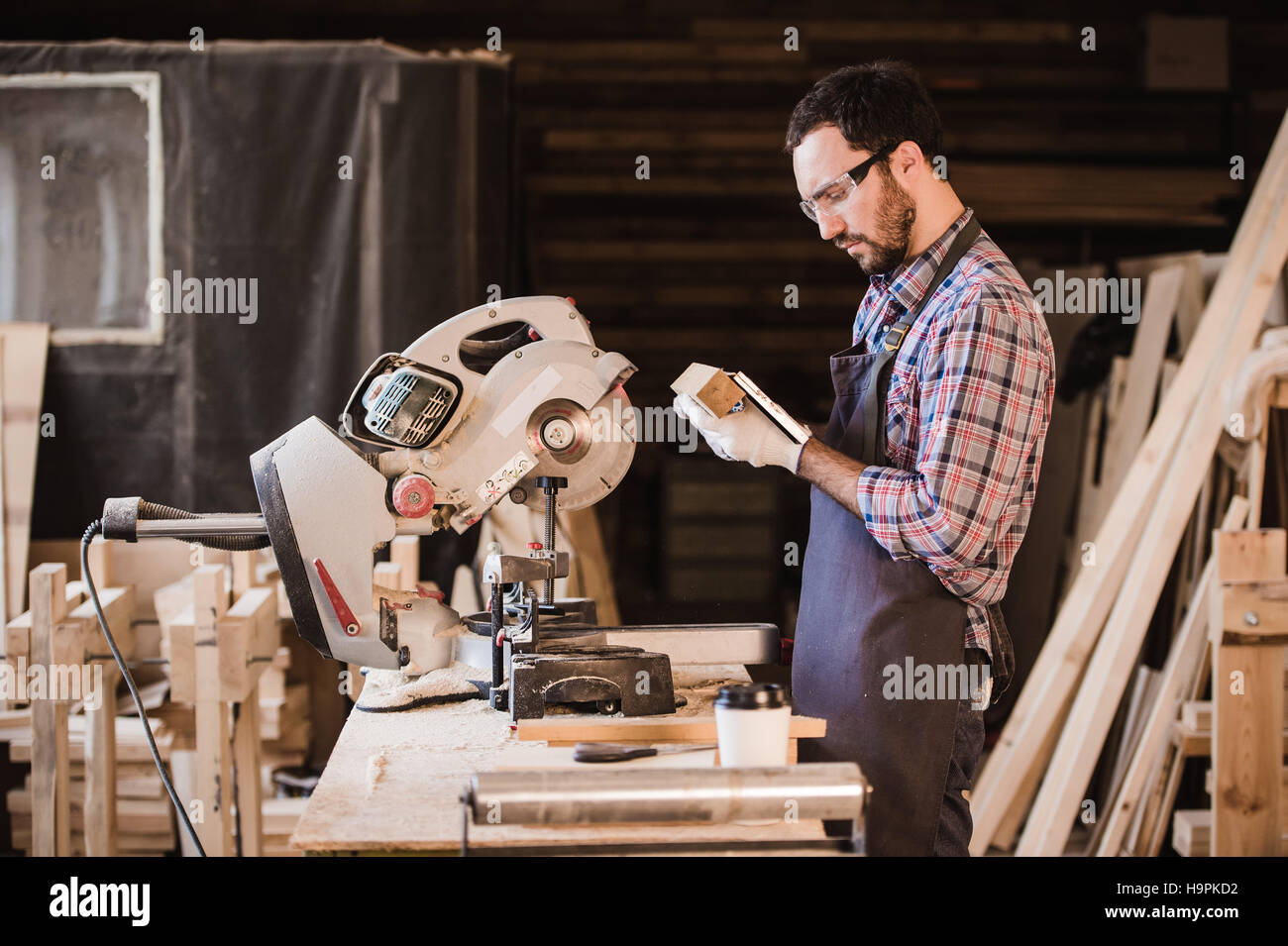 profession, carpentry, woodwork people concept - carpenter with wood ...