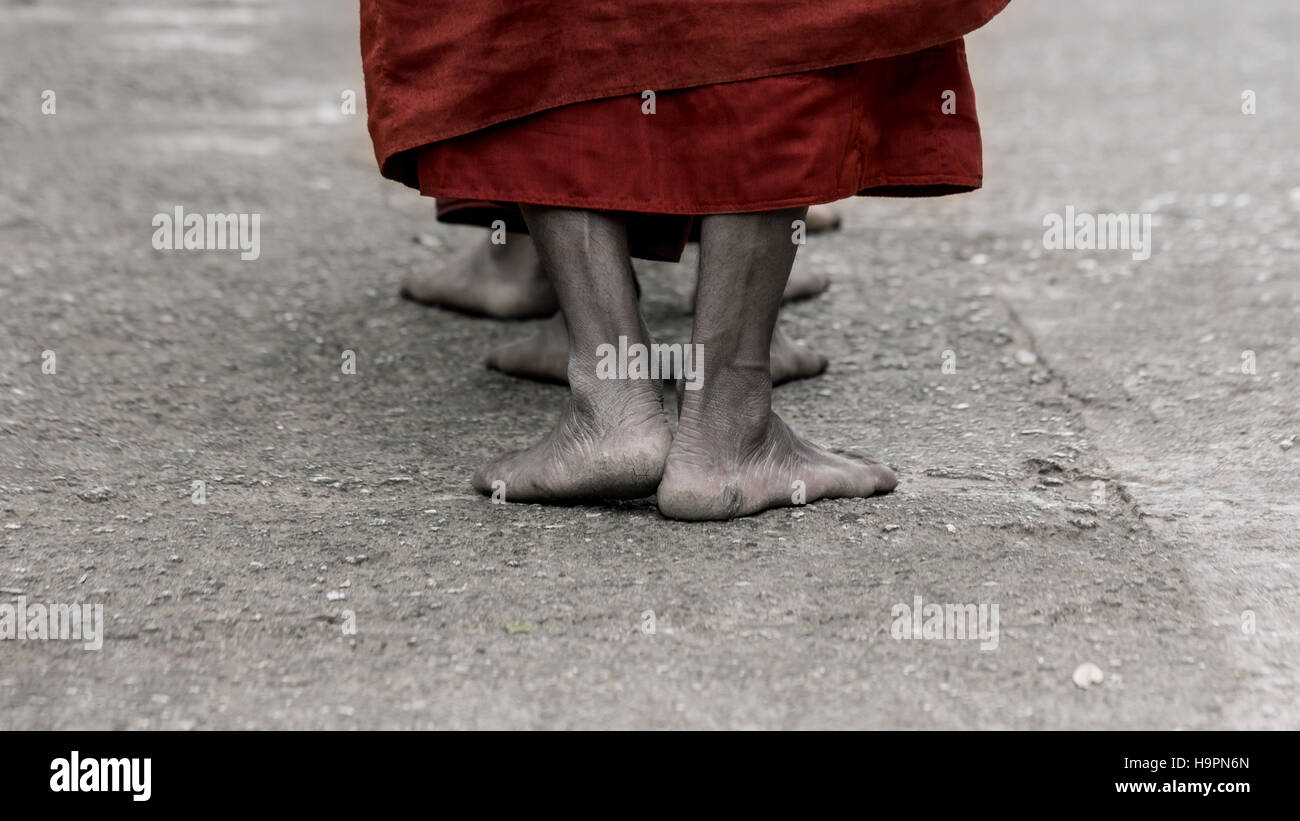 Foots of ascetic Buddhist monk walking at the way to Kyaikhtiyo Stock ...
