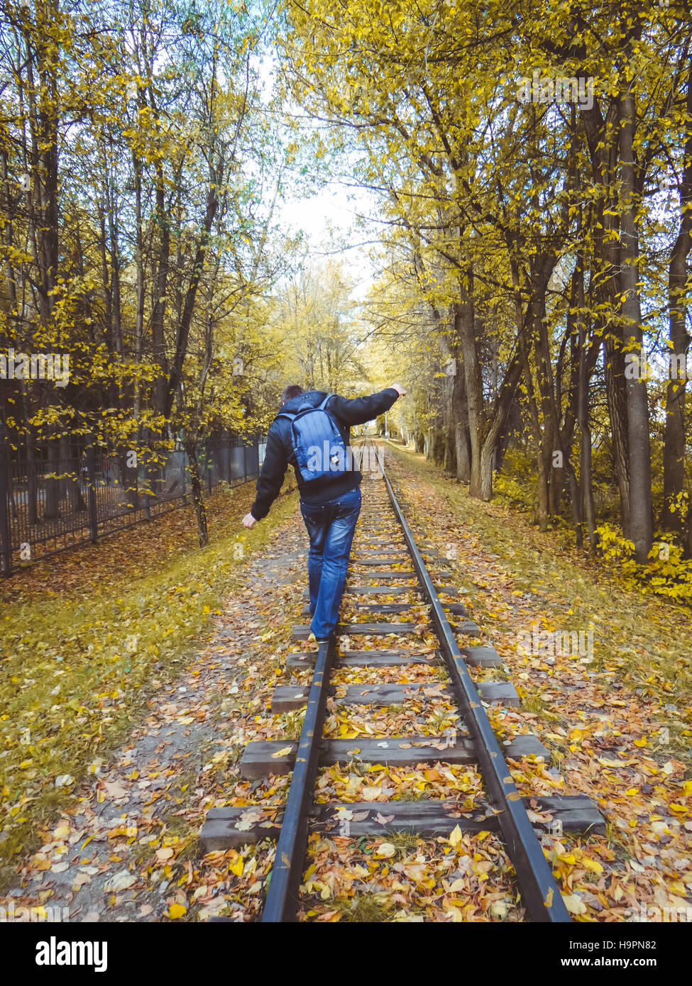 Man walking on the tracks Stock Photo - Alamy