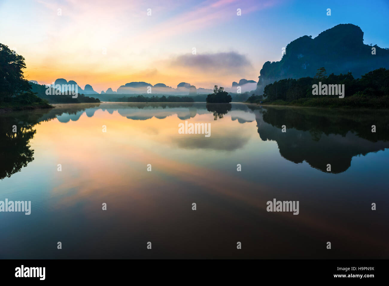 Beautiful sunrise and reflections at natural lagoon, Nongtalay lagoon ...