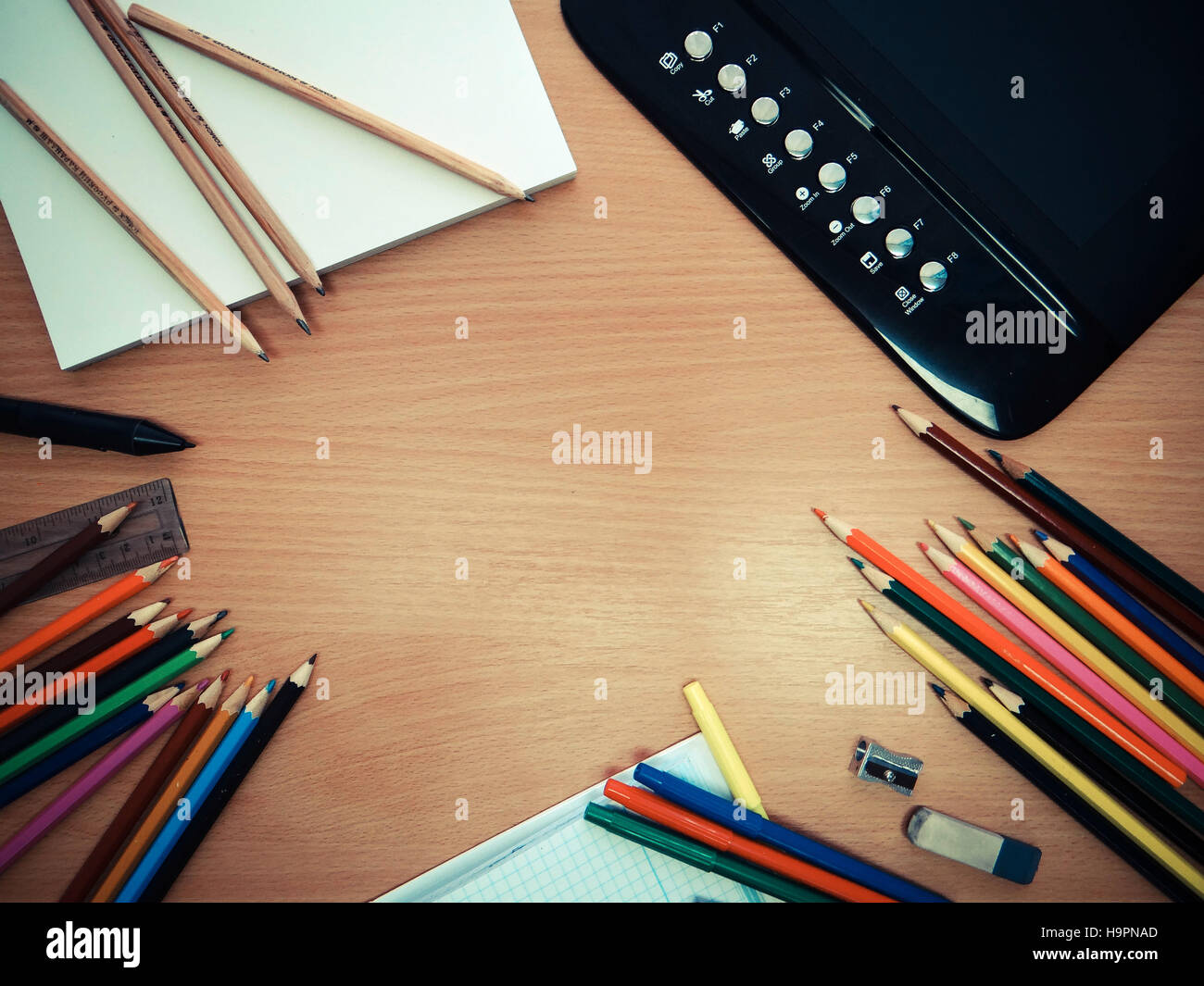office tools, colored pencils and a graphics tablet on the table Stock ...