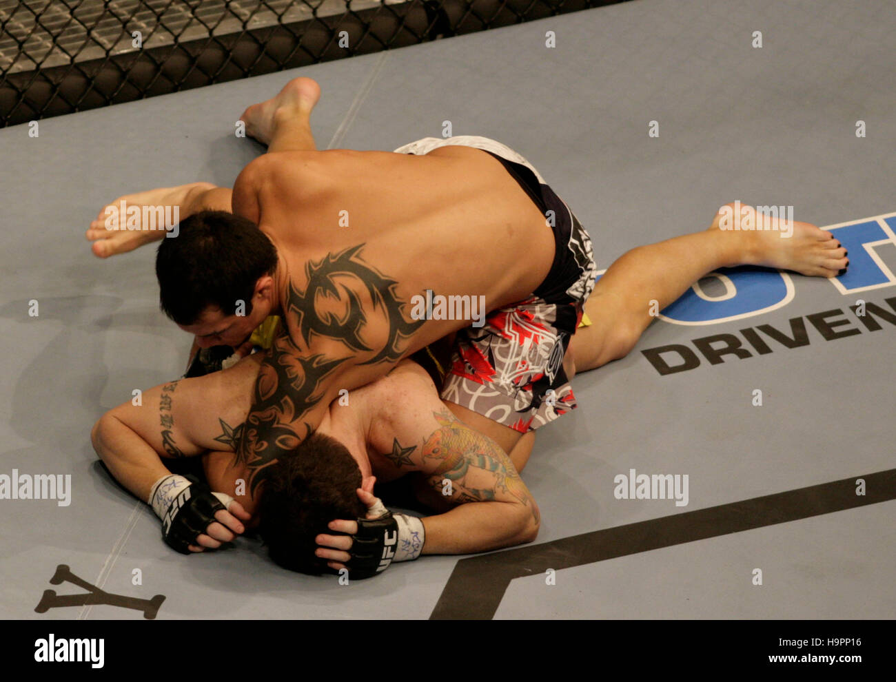 Roger Huerta, top, fights John Halverson at the Ultimate Fighting ...