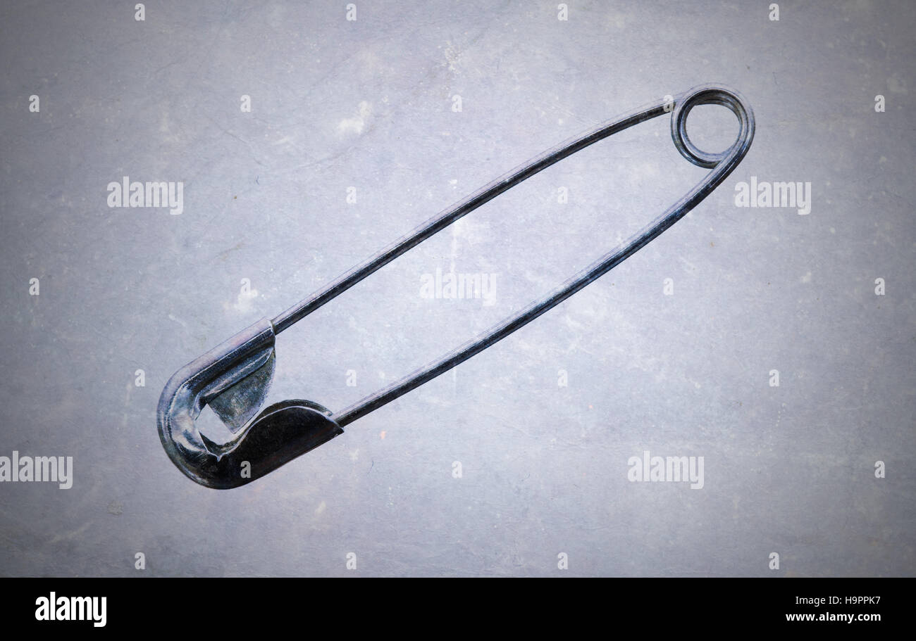 Regular safety pin on an isolated background Stock Photo - Alamy