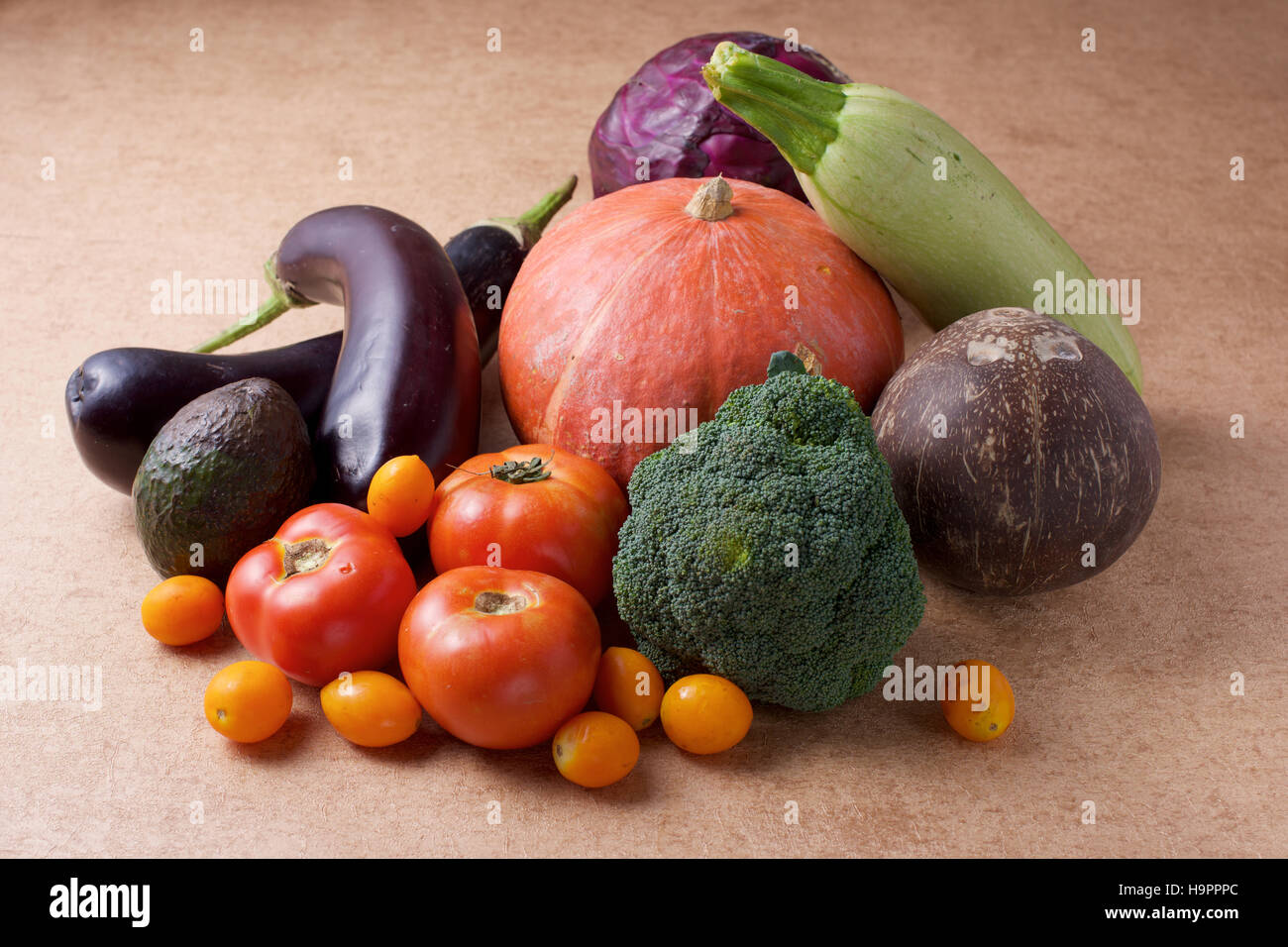 Organic assorted vegetable on light brown background Stock Photo - Alamy