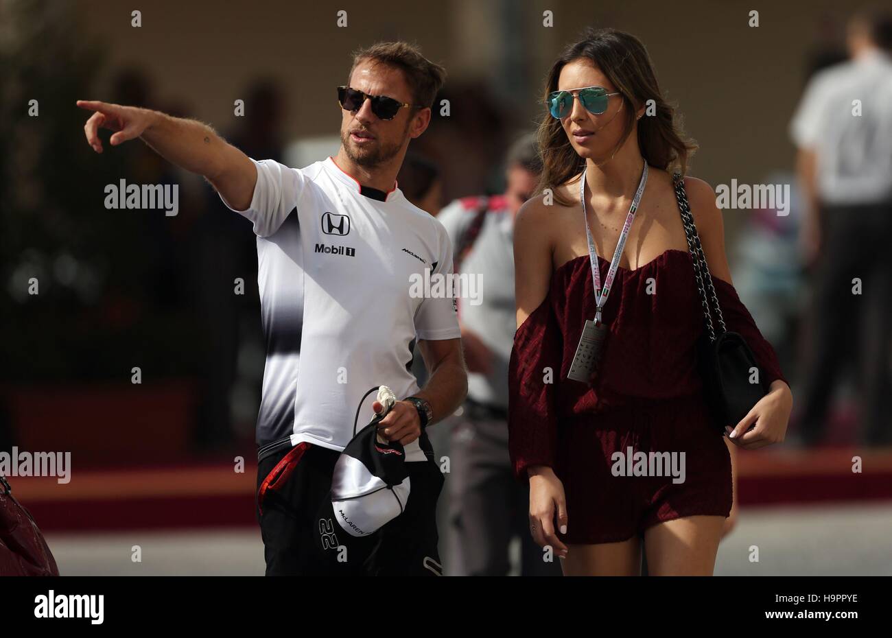 McLaren Honda driver Jenson Button arrives at the circuit with his ...