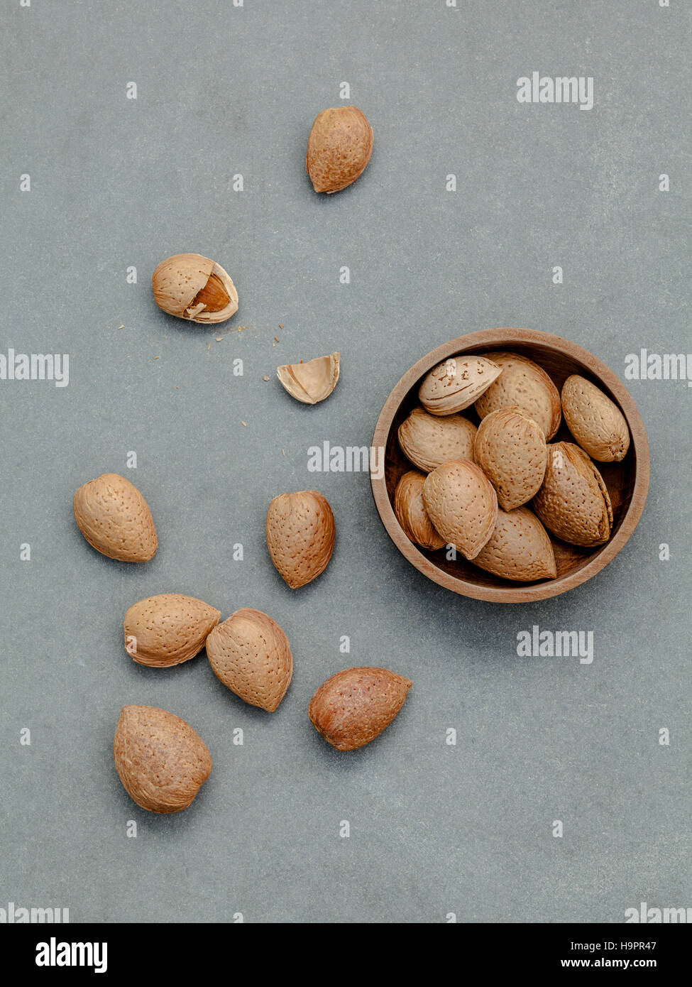 Almonds kernels and whole almonds on concrete background. Whole Stock ...