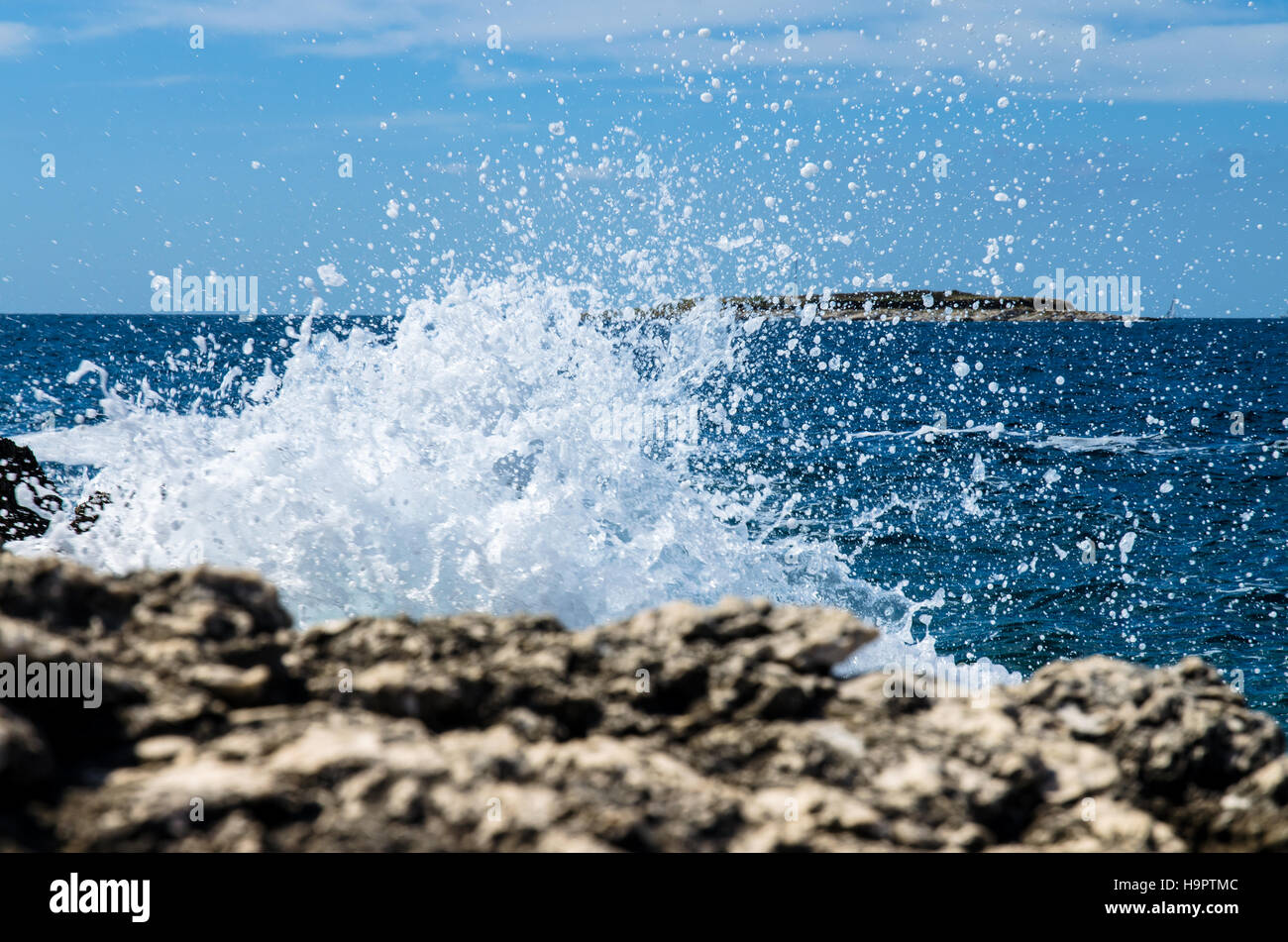 water splash and blue ocean and rocky shore Stock Photo - Alamy