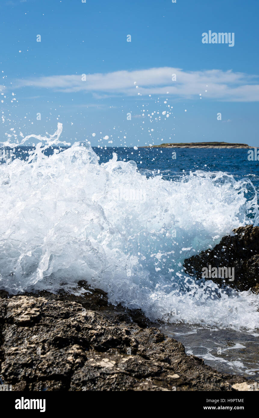water splash and blue ocean and rocky shore Stock Photo - Alamy