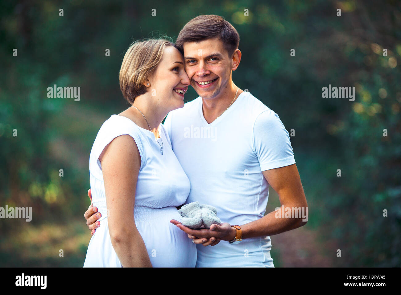Pregnant wife and her husband in park Stock Photo - Alamy