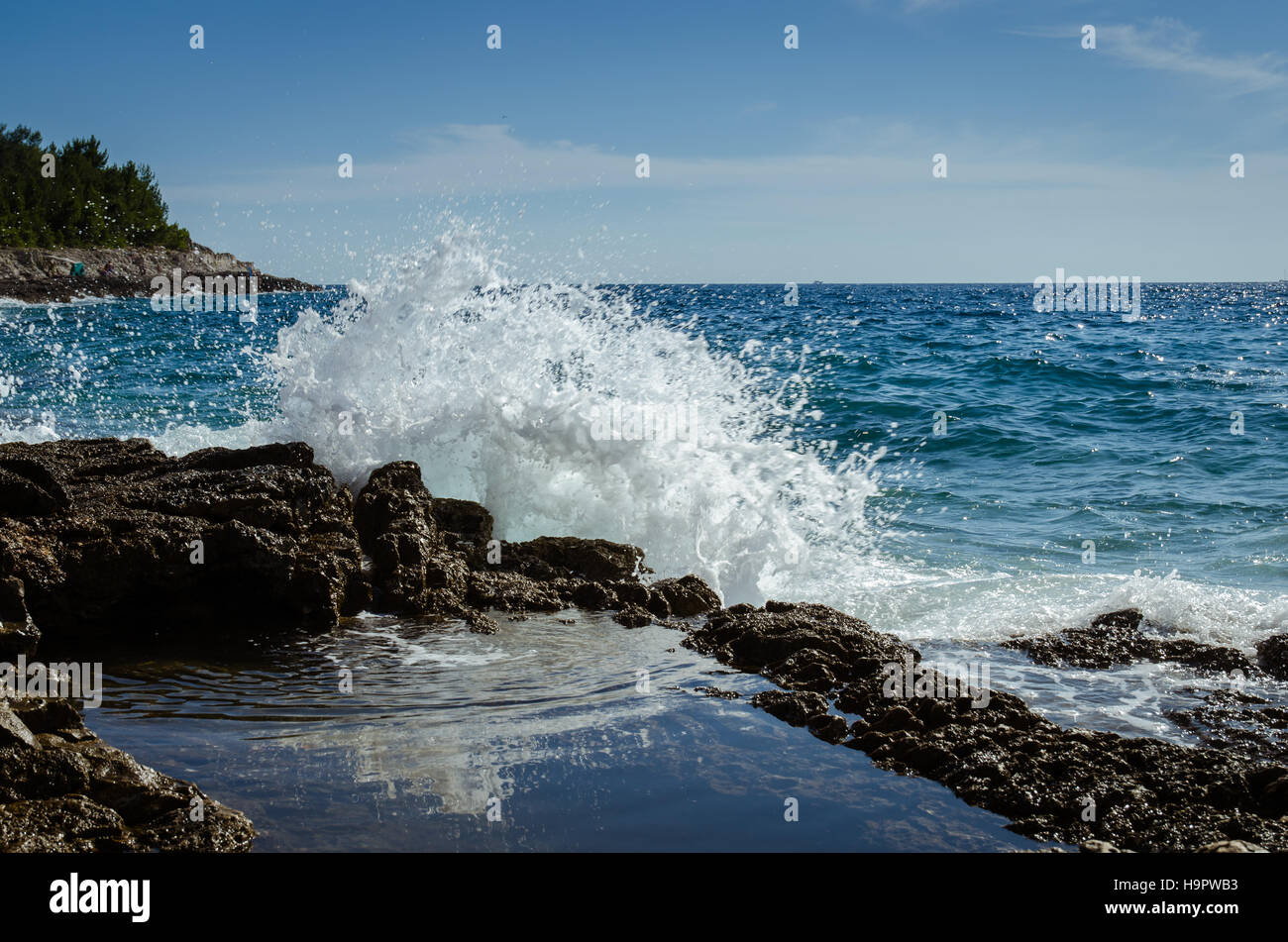 huge water splash on rocky coast and blue sea Stock Photo - Alamy