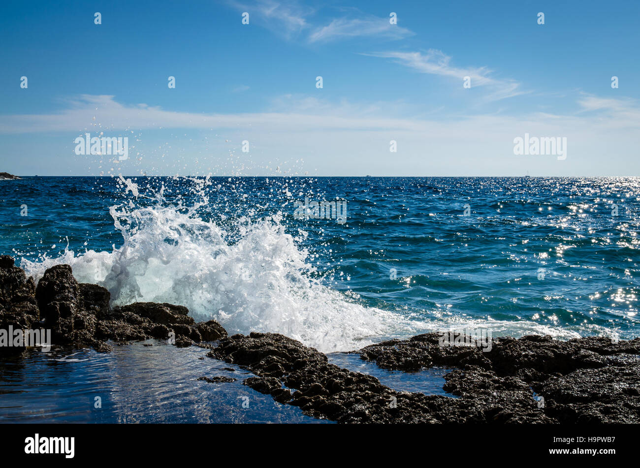 huge water splash on rocky coast and blue sea Stock Photo - Alamy