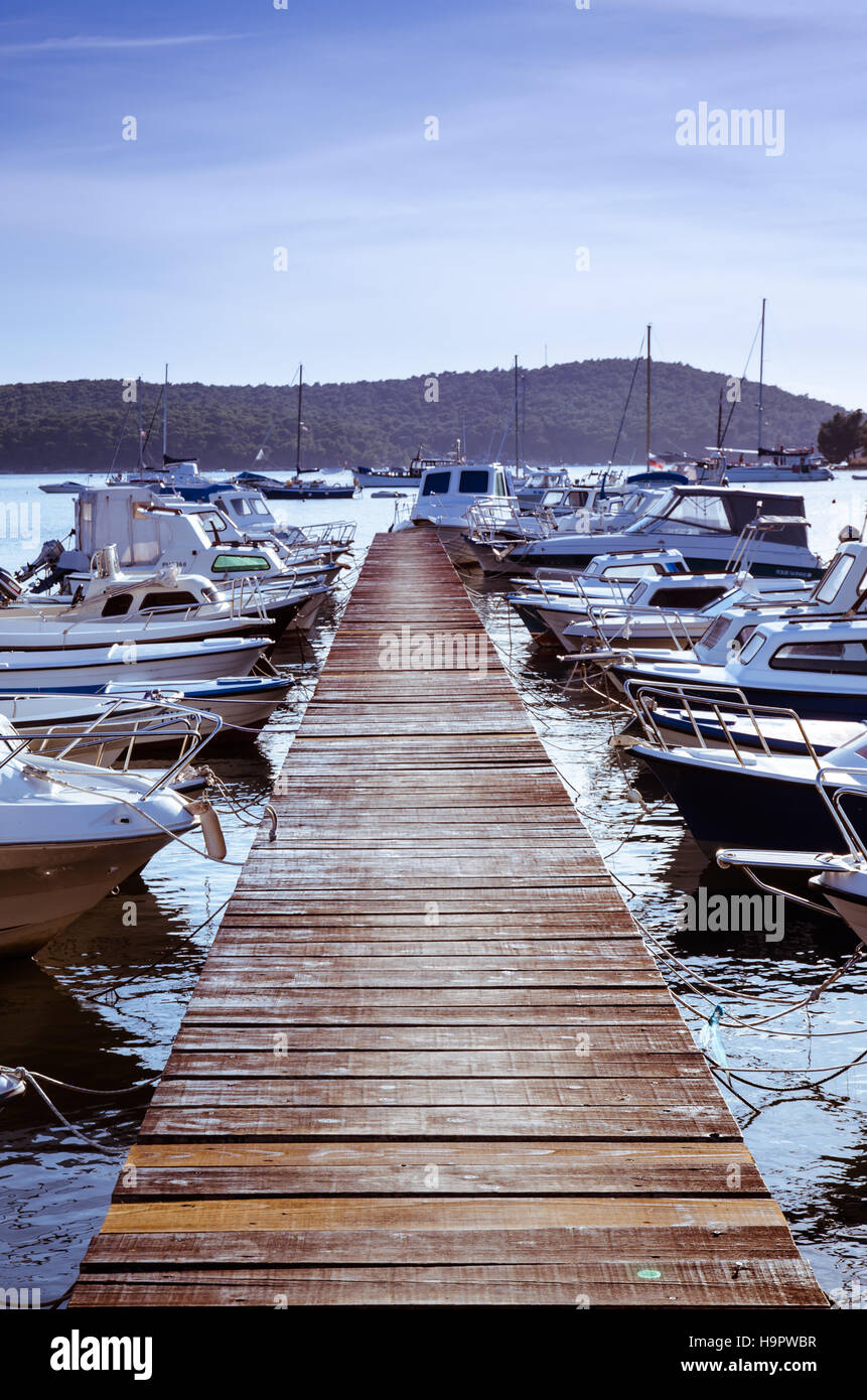 wooden jetty with many boats at anchor Stock Photo - Alamy