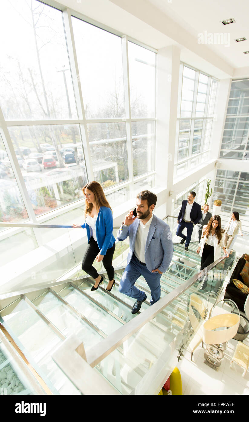 Young business people climb the stairs in the office building Stock ...