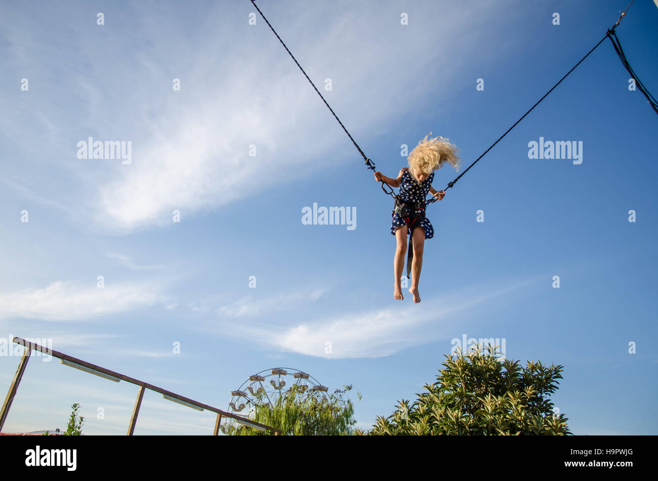 little courageous kid jumping in bungee attraction Stock Photo - Alamy