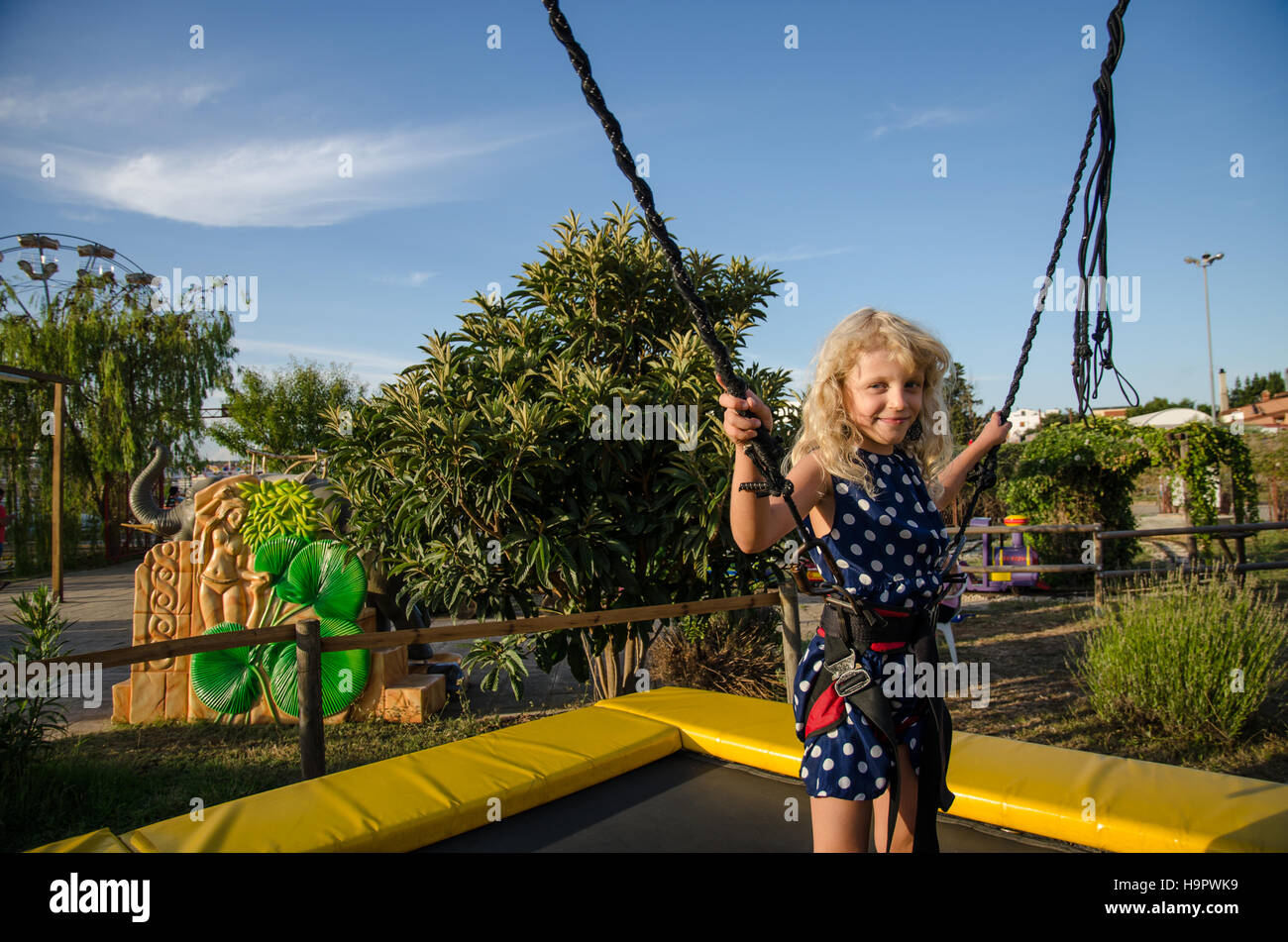 girl in preparation for bungee attraction Stock Photo - Alamy