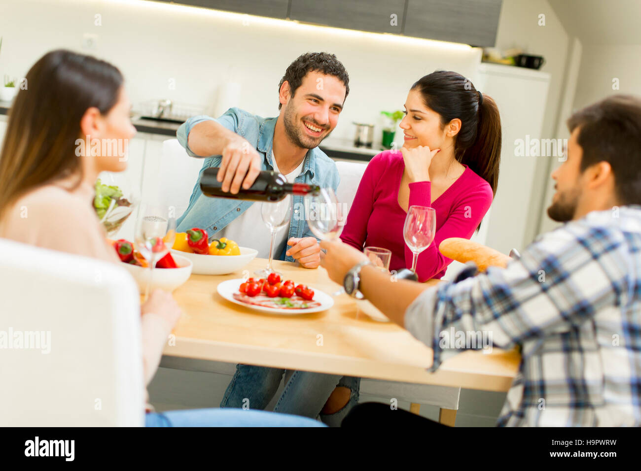 Happy young people sitting hi-res stock photography and images - Alamy