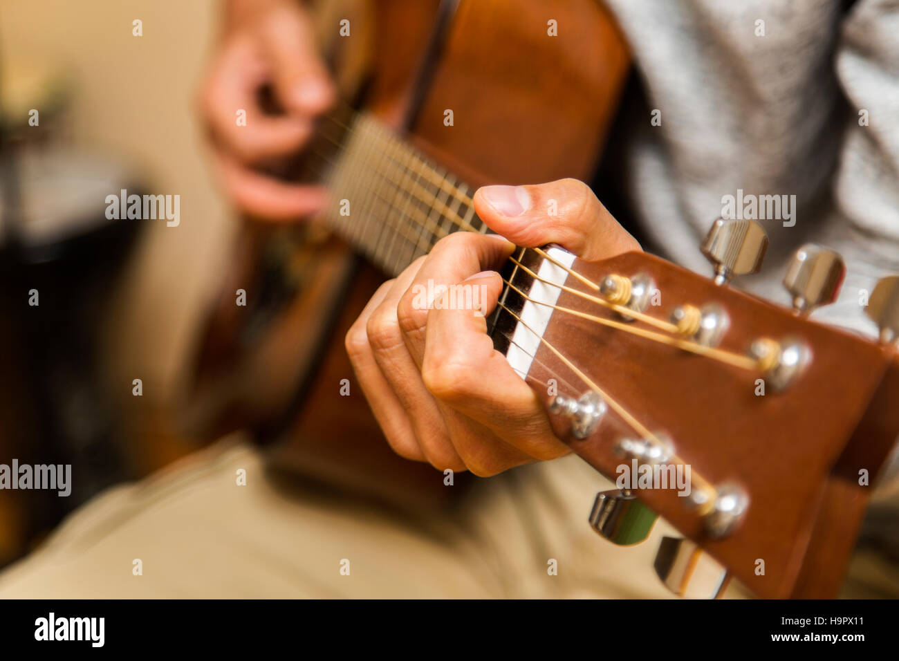 Handsome young men playing guitar hi-res stock photography and images ...