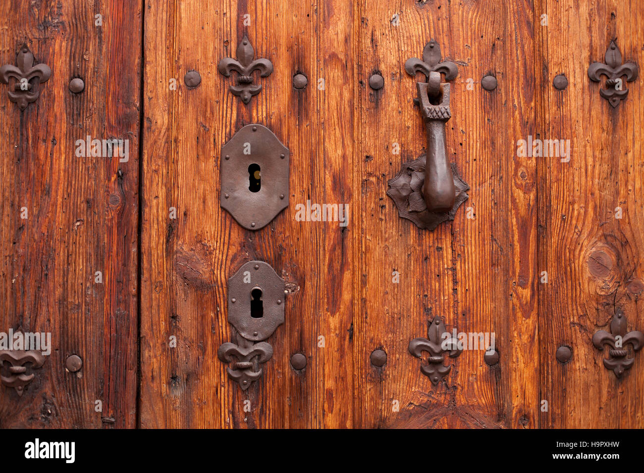 Nice old door with wrought iron decoration Stock Photo - Alamy