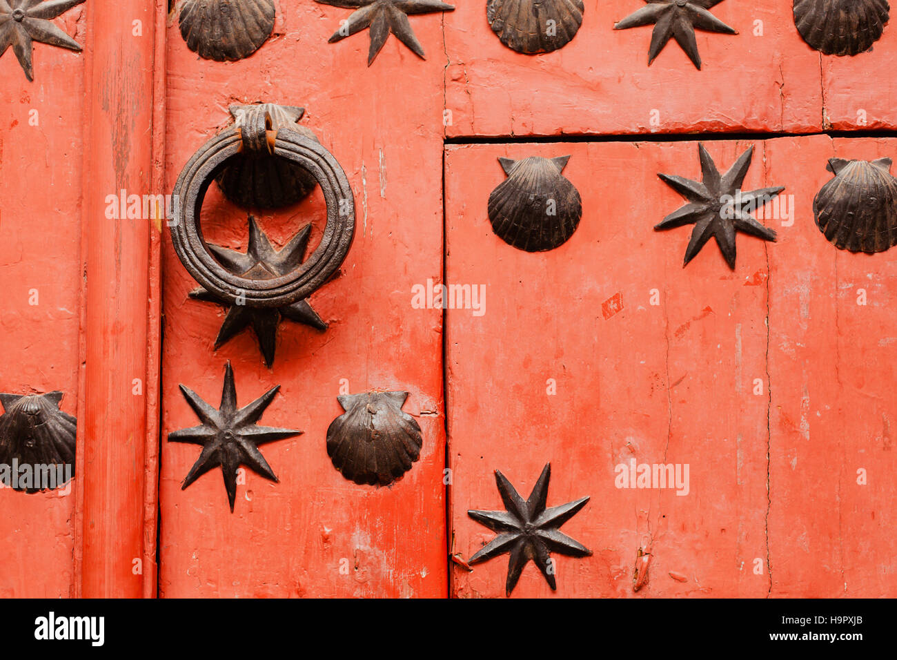 Nice old door with wrought iron decoration Stock Photo - Alamy