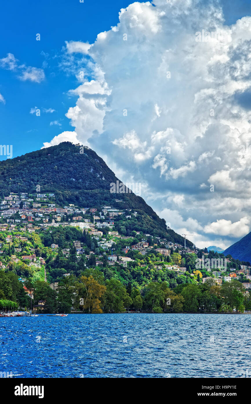 Swiss houses at Lake Lugano and Alps mountains in Lugano, Ticino canton ...
