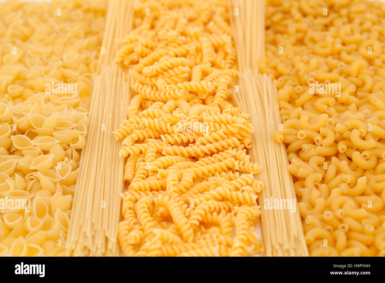 different types of raw pasta as background Stock Photo - Alamy
