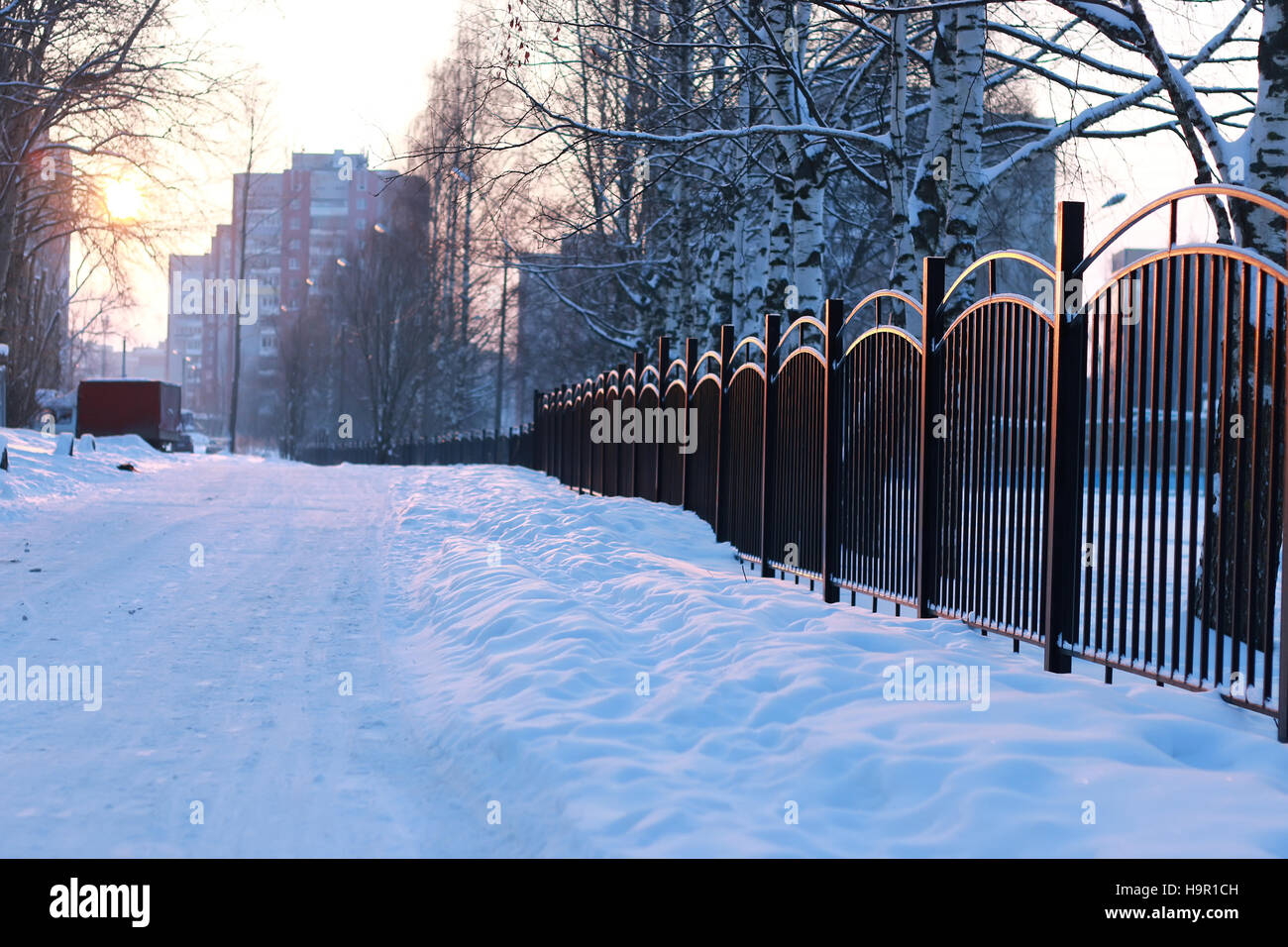 winter landscape iron fence at sunset Stock Photo - Alamy