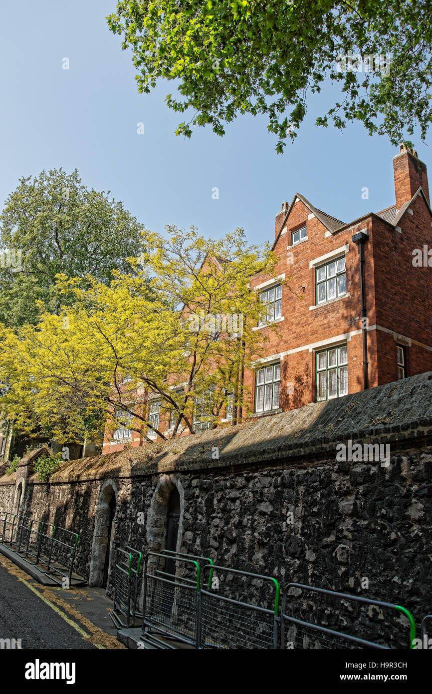Traditional brick building with a gate and green trees at Bankside in ...