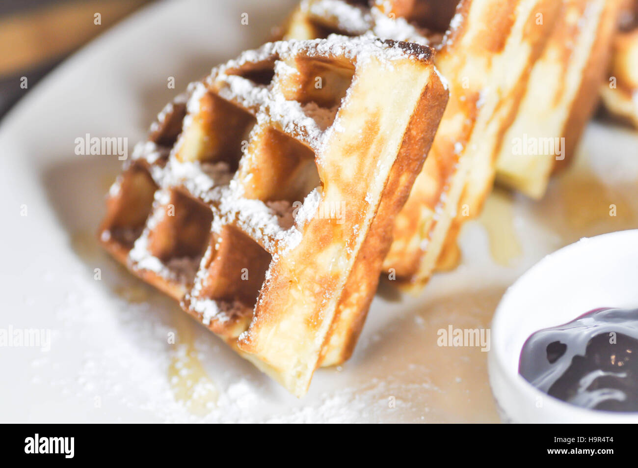 waffle with icing sugar and blueberry dip Stock Photo - Alamy