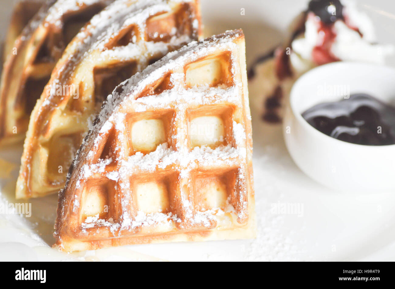 waffle with icing sugar , whipped cream and blueberry dip Stock Photo ...